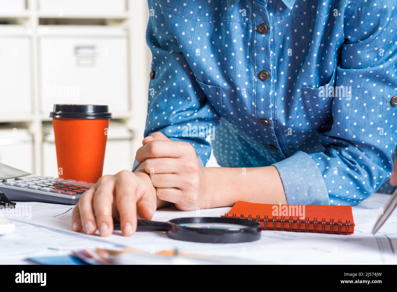 Architect standing near desk with blueprints Stock Photo - Alamy
