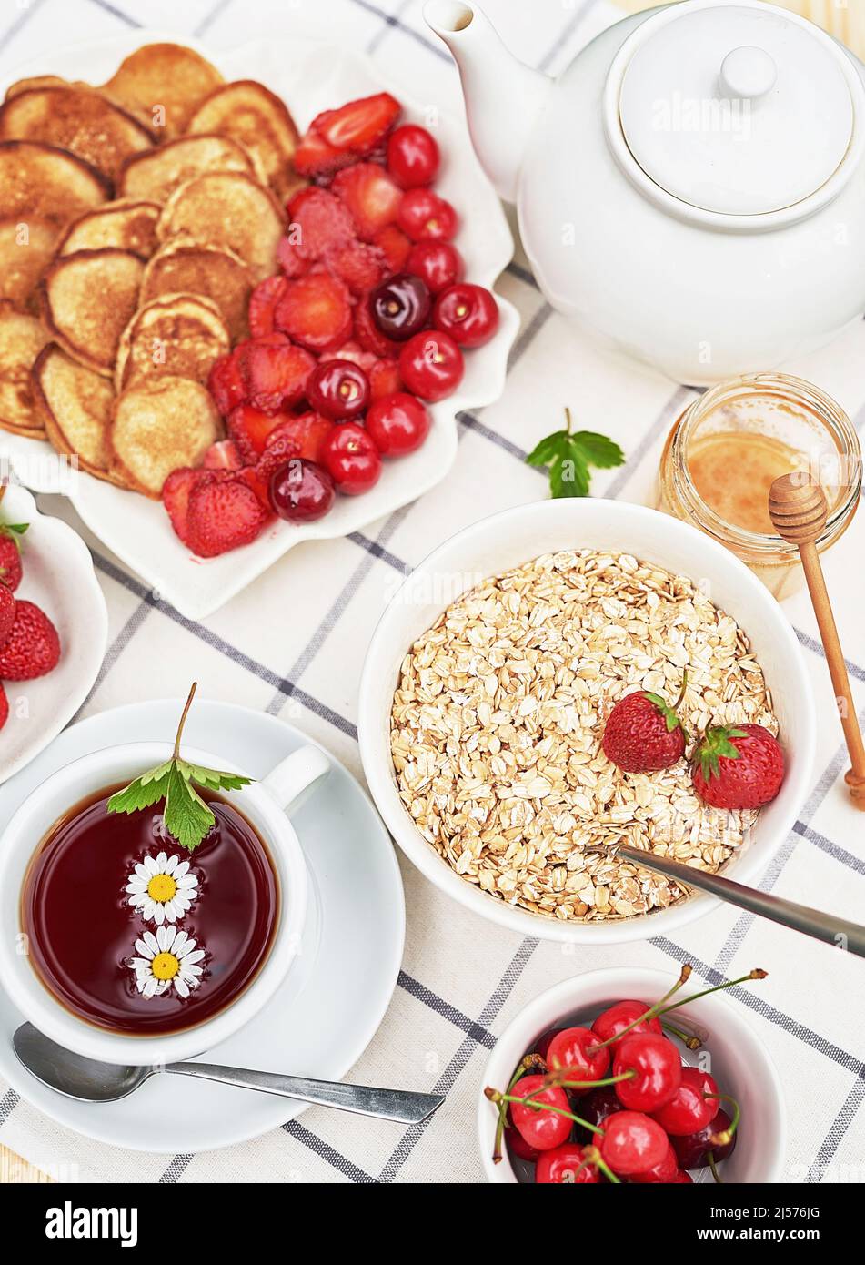 Breakfast outside. Strawberries, cherries, mini pancakes oatmeal. and ...