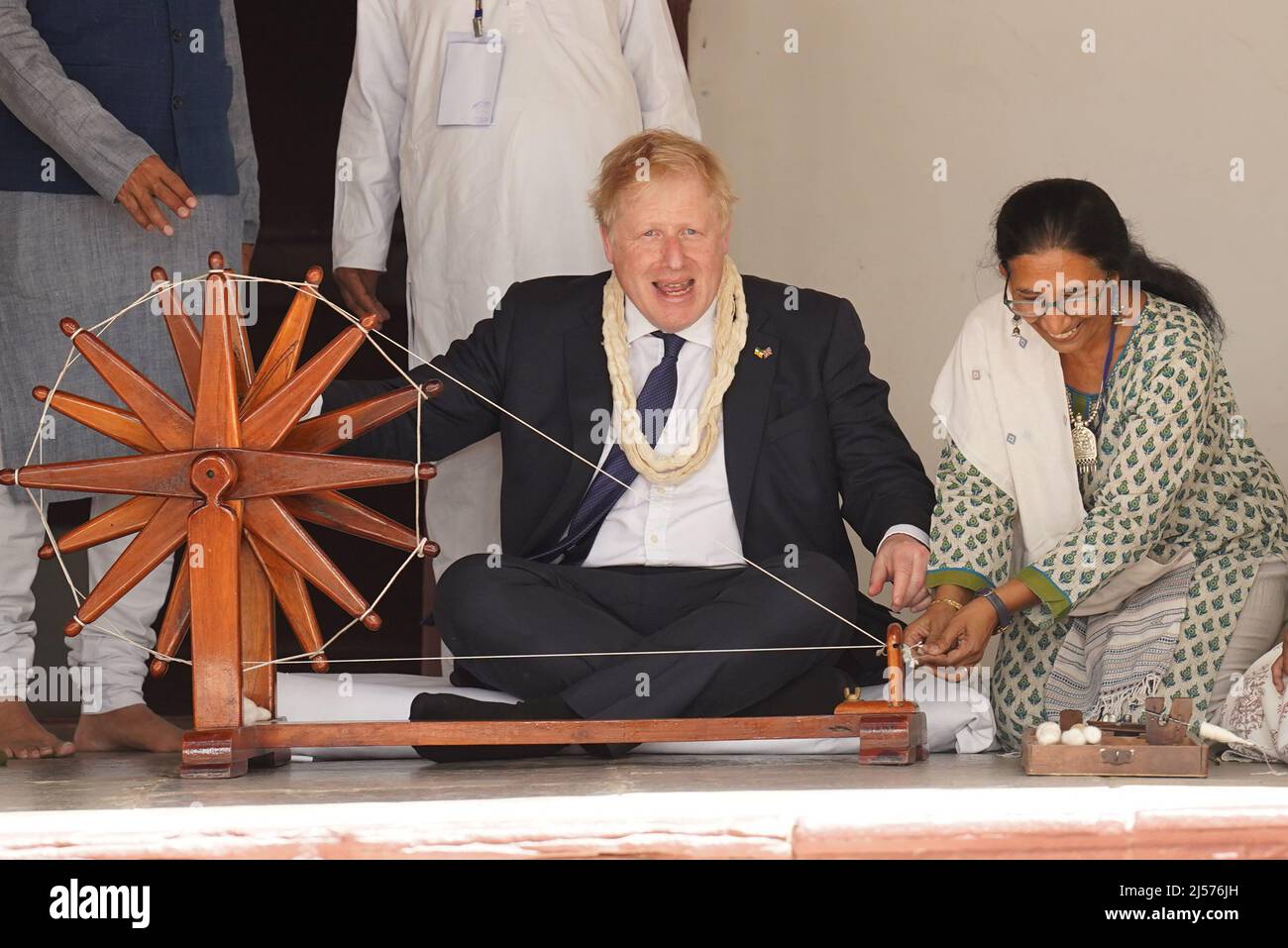 Prime Minister Boris Johnson is show how to operate a cotton wheel at ...