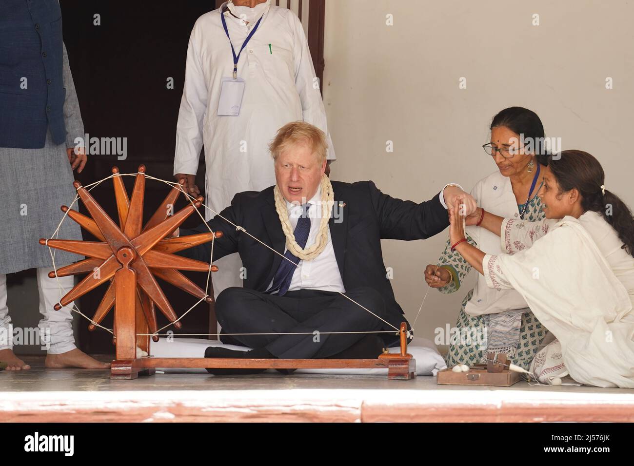 Prime Minister Boris Johnson is show how to operate a cotton wheel at ...