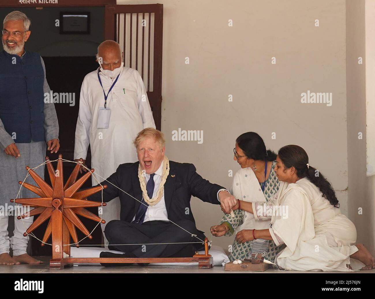 Prime Minister Boris Johnson is show how to operate a cotton wheel at ...