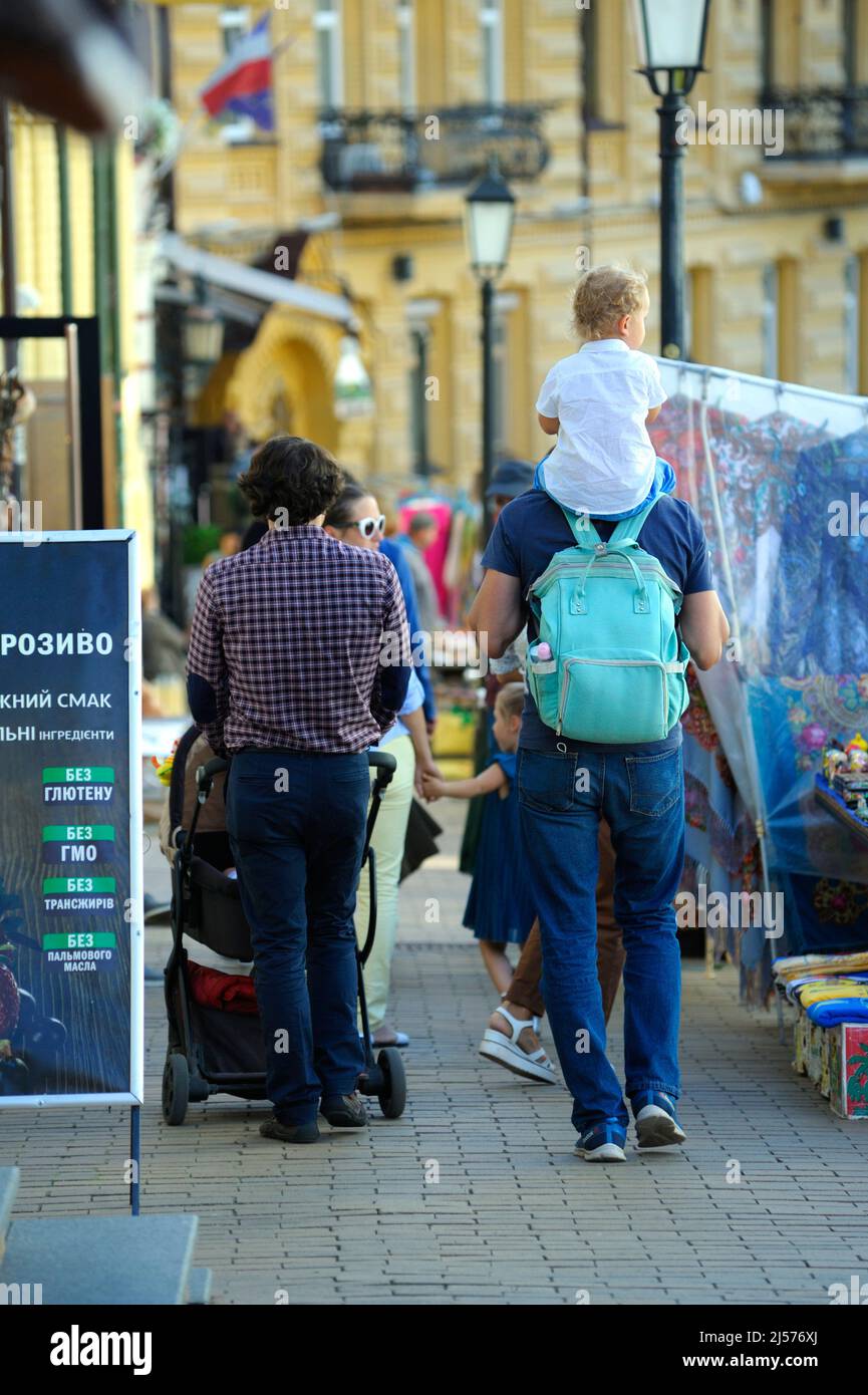 People walking down the street, buildings on a background. Day of ...
