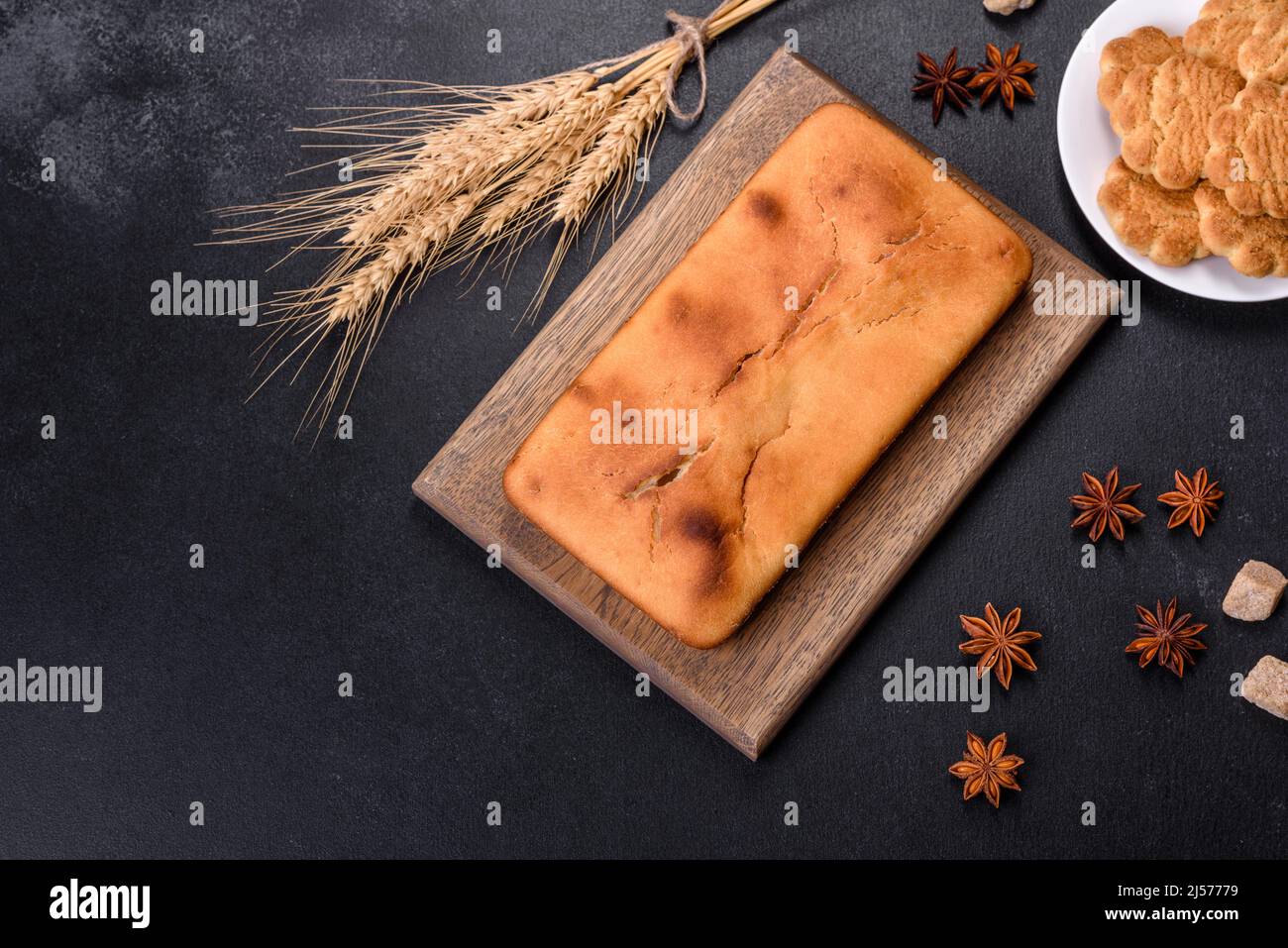 Baked rectangular cupcake with raisins and chocolate on a dark concrete ...