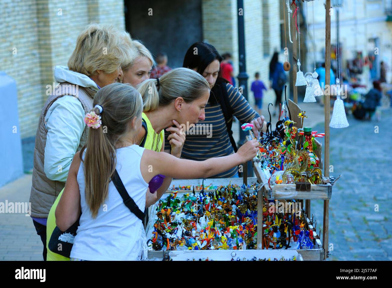 Woman street seller selling souvenirs placed on a stall counter, women ...