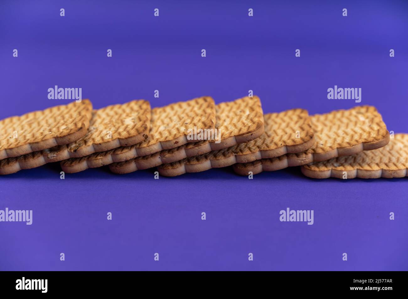 A stack of rectangular cookies against a blue background. Ready-to-eat ...