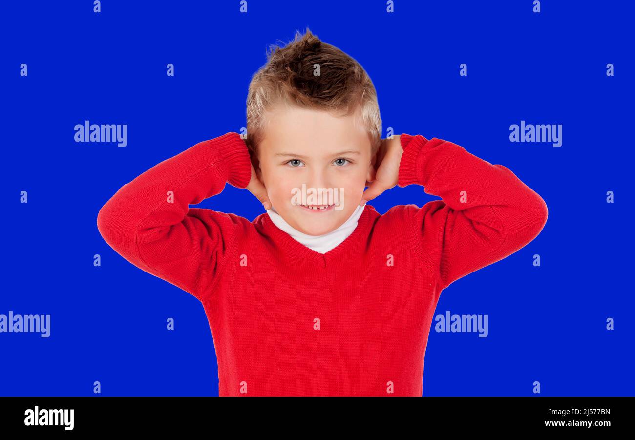 Annoyed child beacouse of a loud noise isolated on a blue background ...