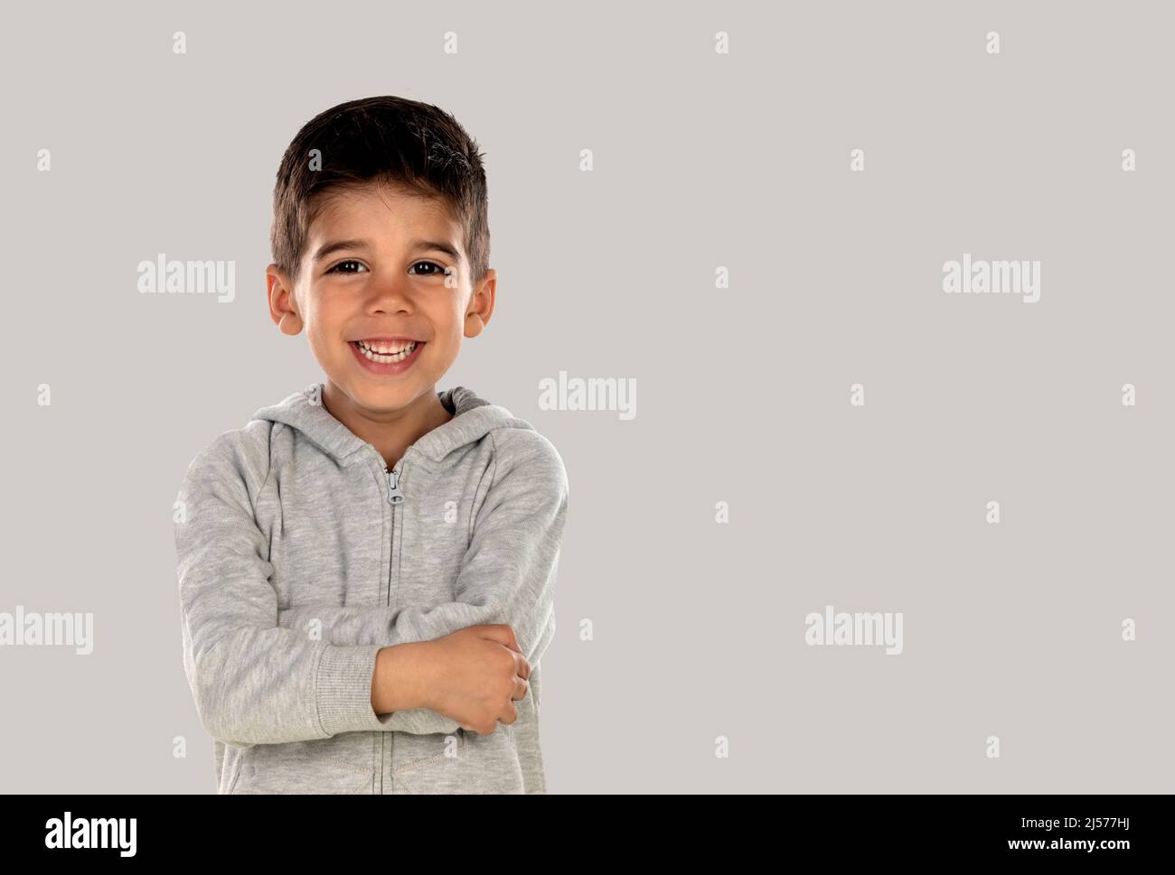 Happy child with his arms crossed isolated on a grey background Stock ...