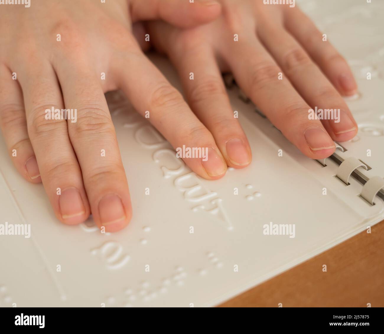 A woman learns the Braille alphabet using a decoder Stock Photo - Alamy