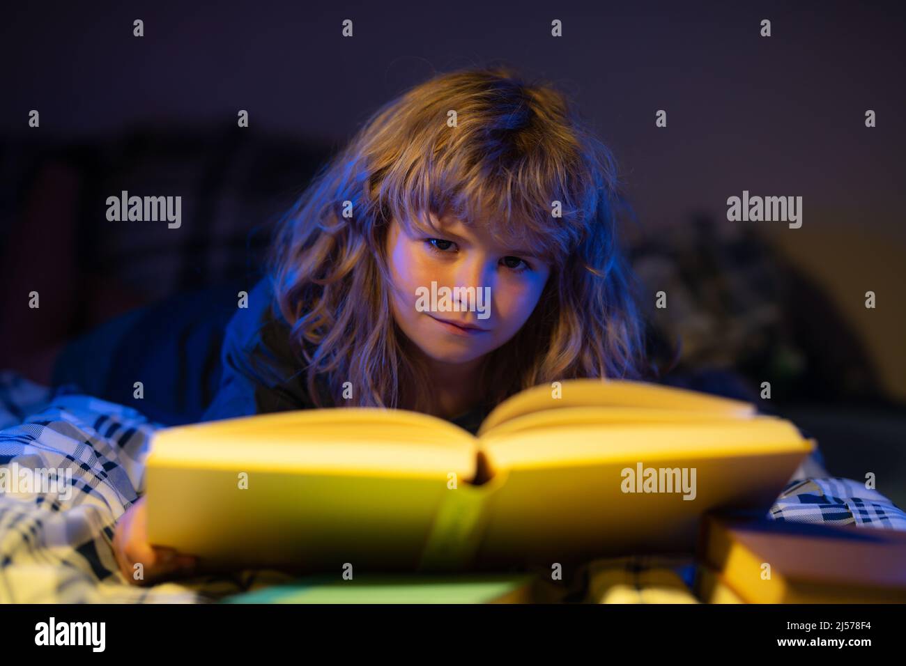 Happy childhood, dreaming child. Child reading book. Little boy read ...