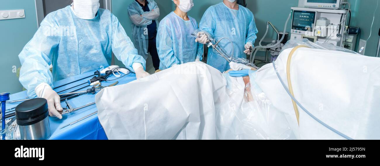 Surgeons operate on the patient in the operating room. A team of ...