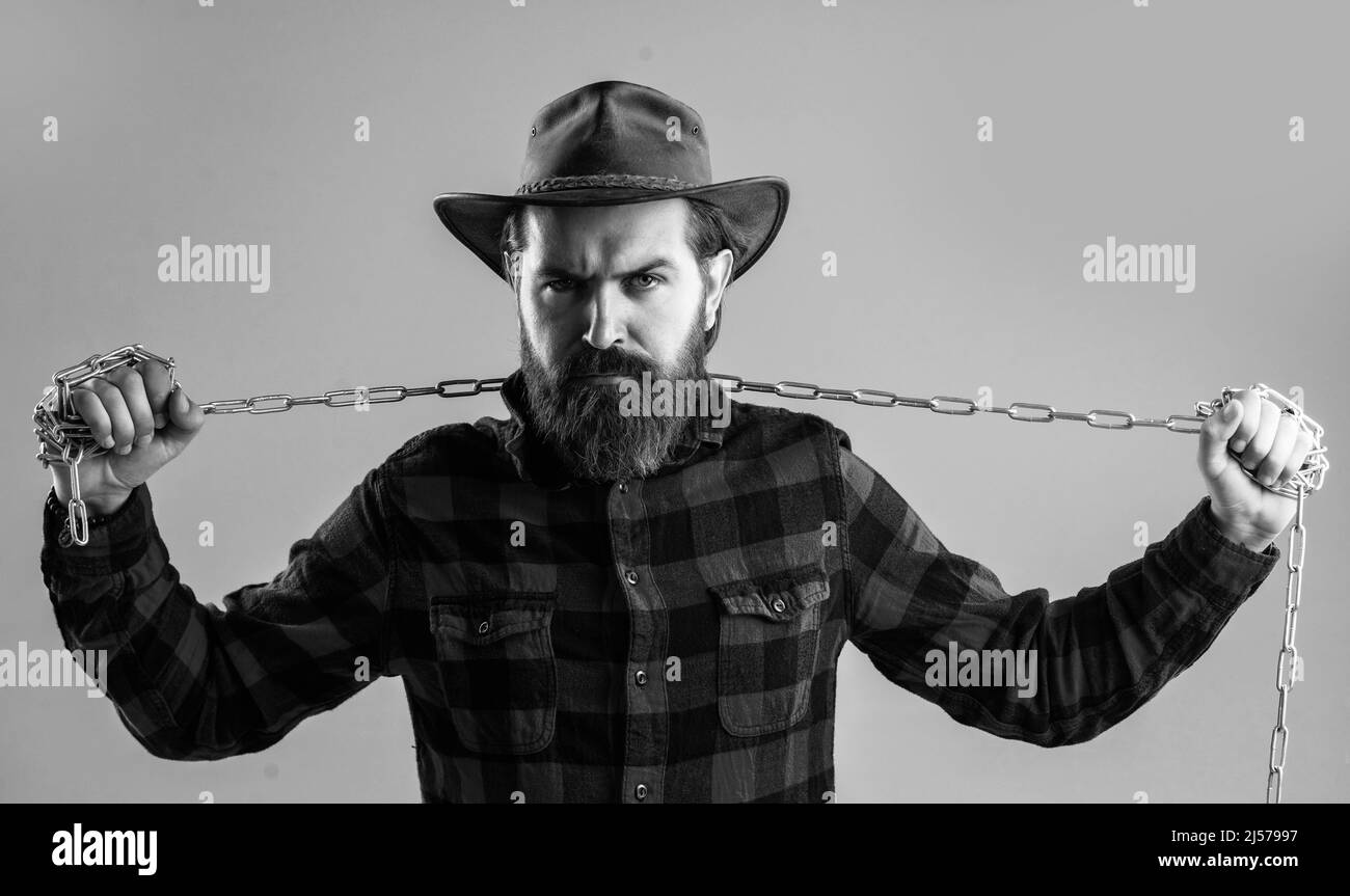 Do not give up. chained up in chains. bearded man has aggressive look ...