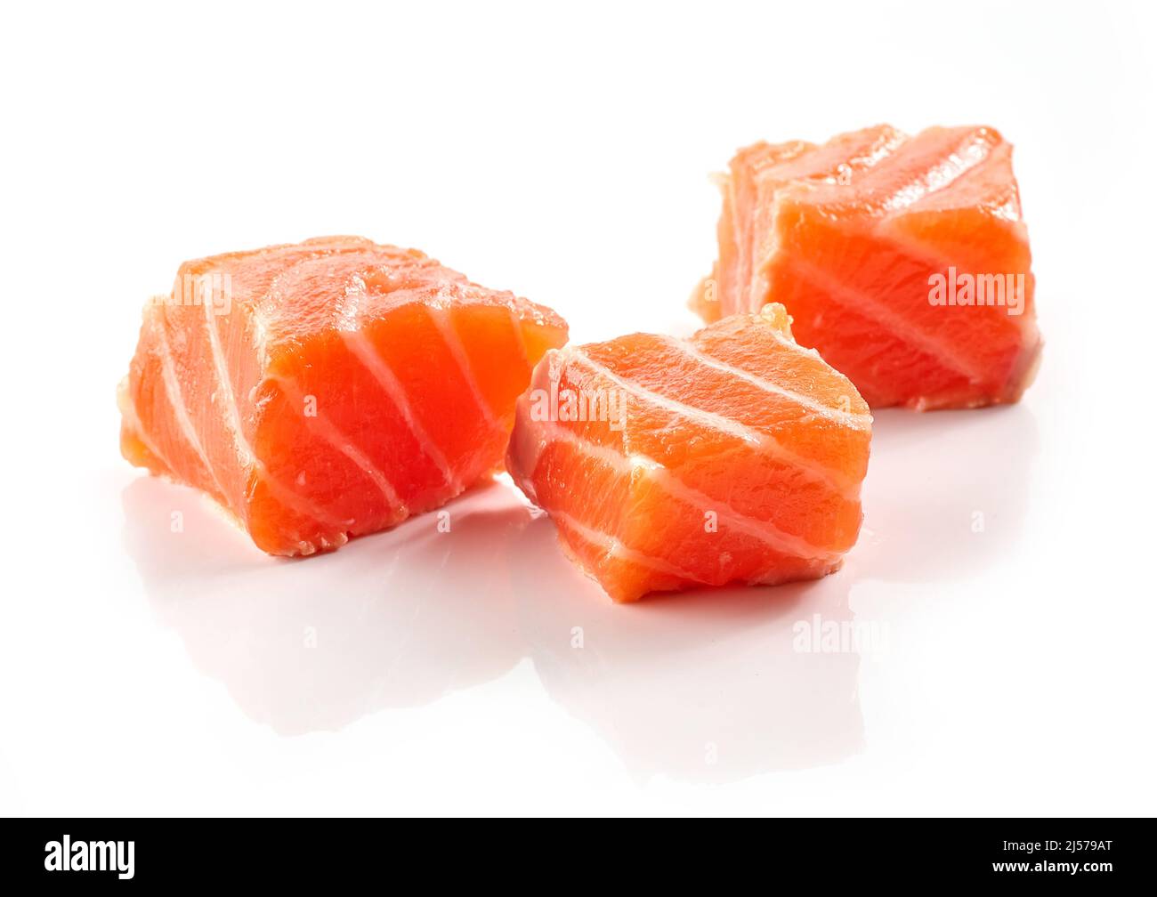 fresh raw salmon cubes pieces isolated on white background Stock Photo ...