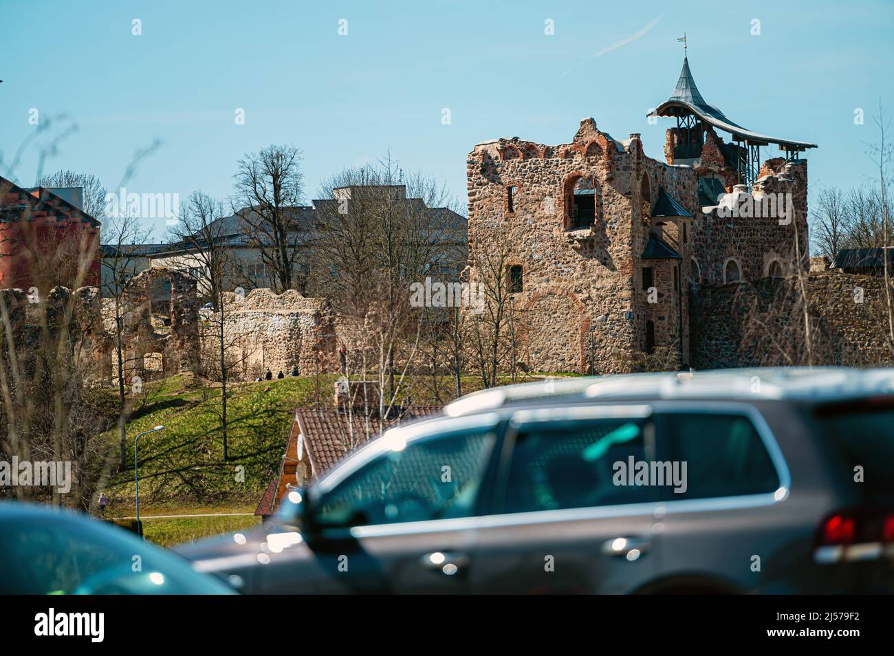 ancient Livonian Order castle ruins against the background of parked ...