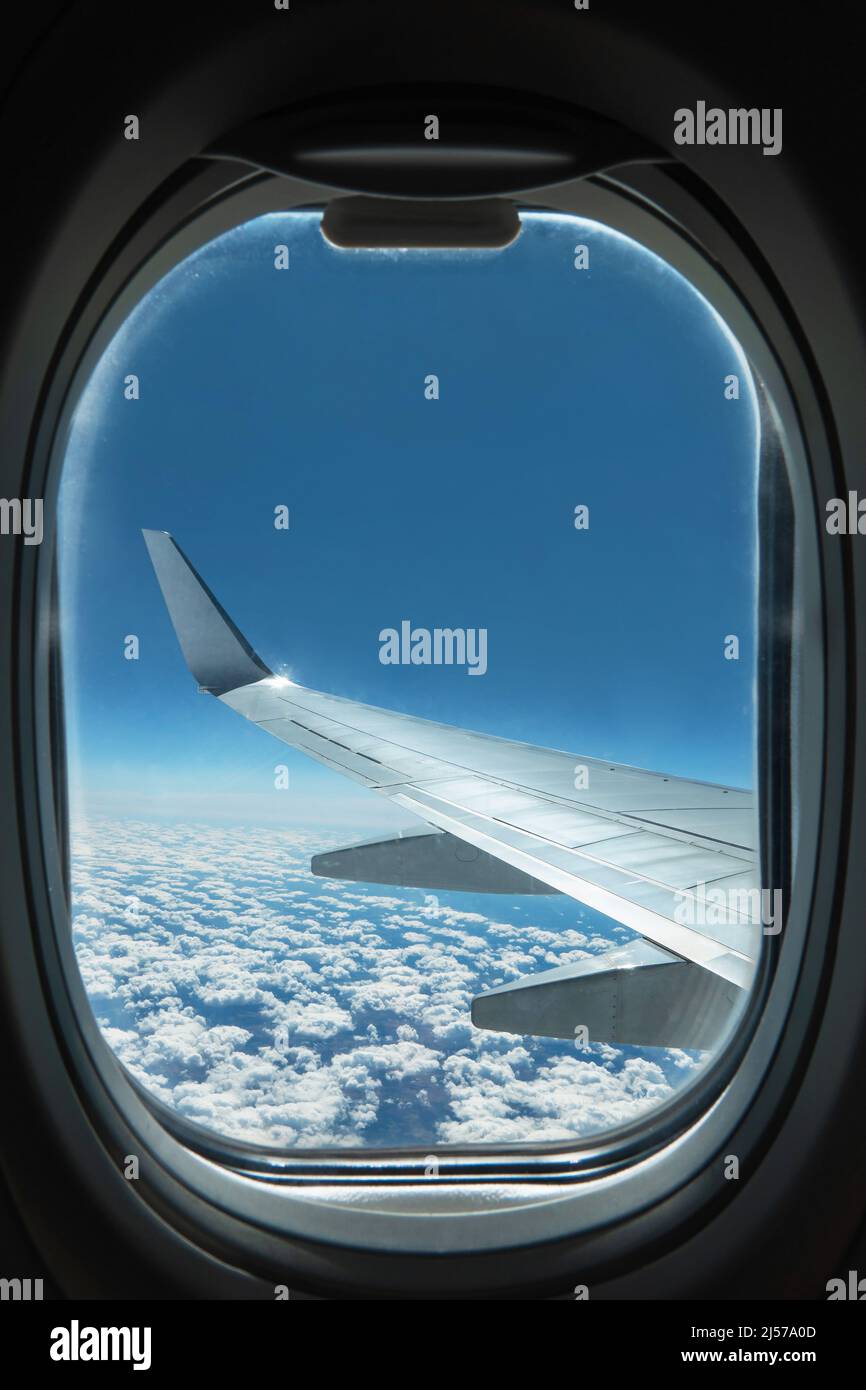 View from airplane window on an aircraft wing and sky with clouds Stock ...