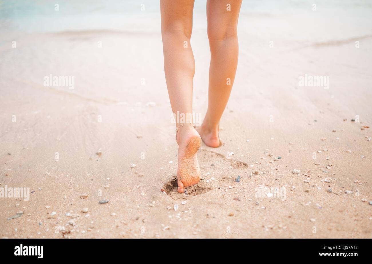 Female Legs Walking Along The Seaside Barefoot Close Up Of The Perfect