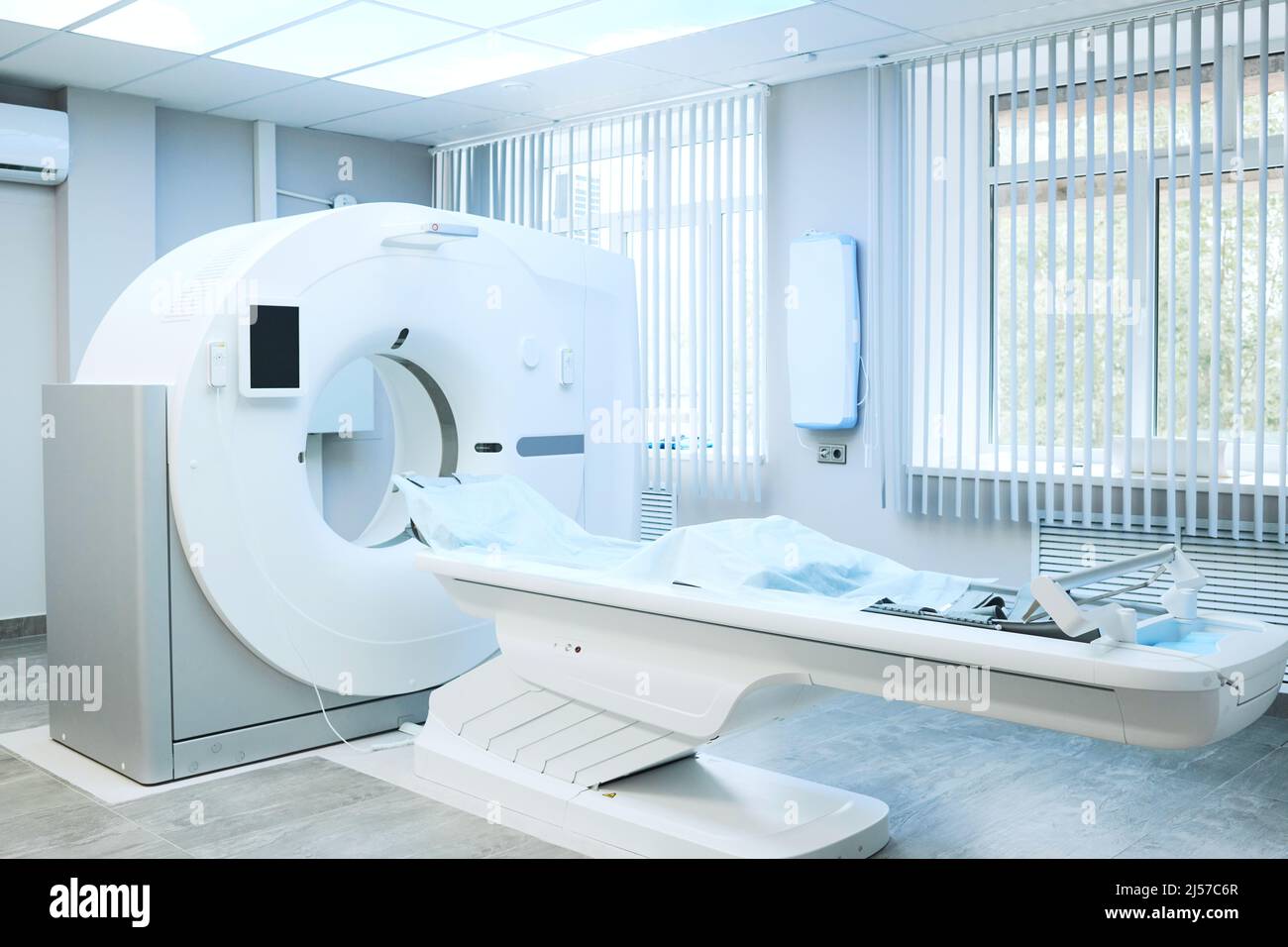 Modern large computer tomography machine with table covered with ...