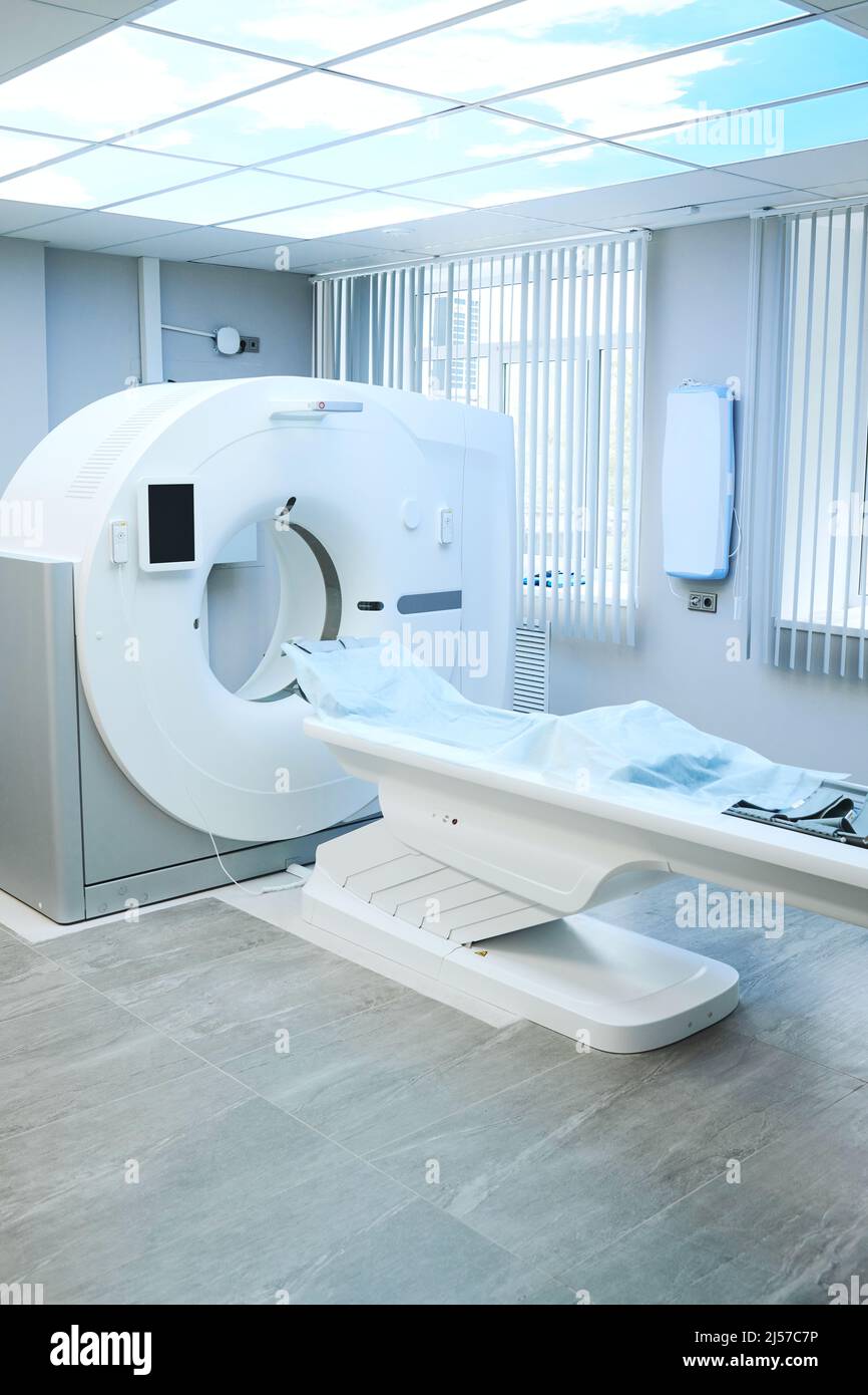 New MRI scan with long table covered with disposable sheet and digital ...