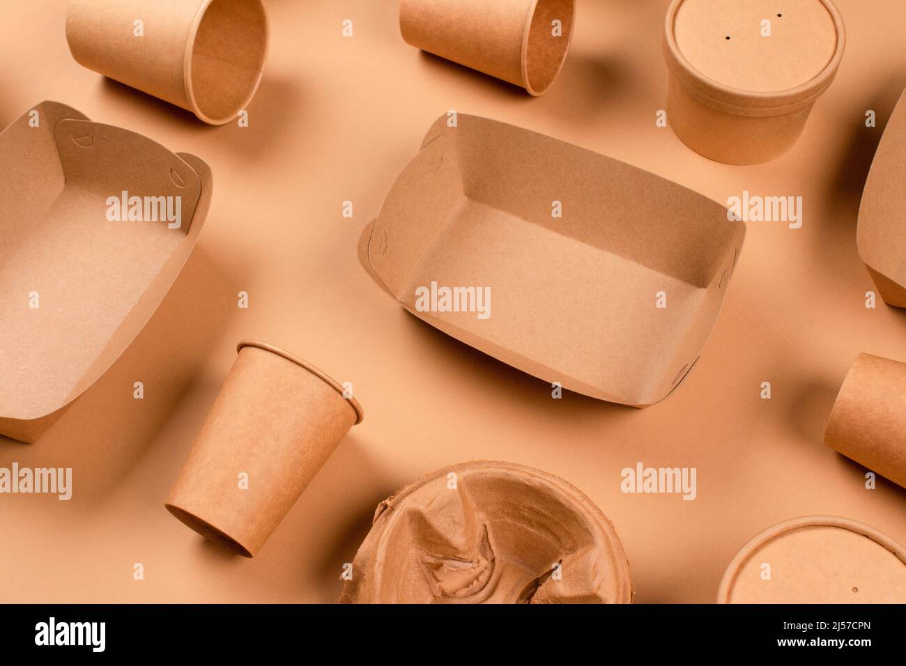 Eco-friendly tableware and kraft paper food packaging on kraft paper background - paper cups ...