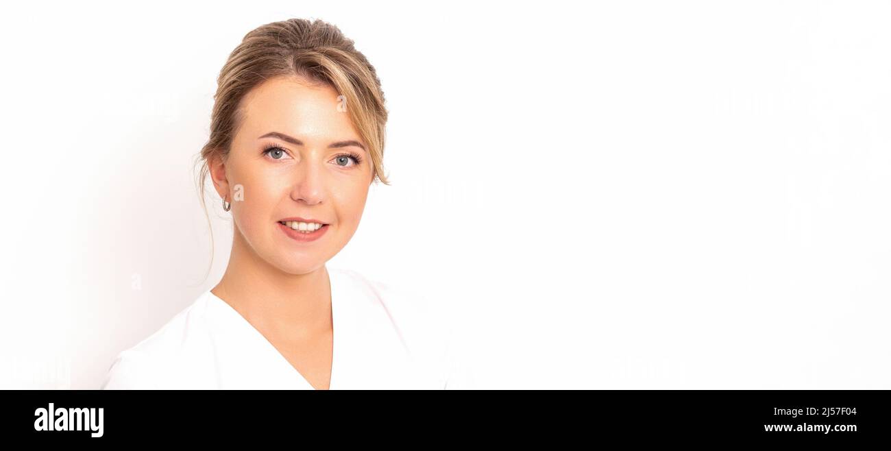 Close-up portrait of young smiling female caucasian healthcare worker ...