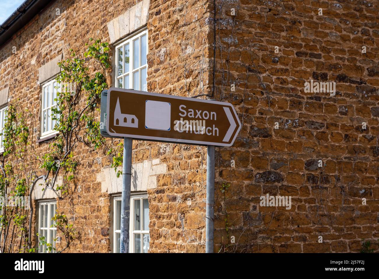 Brown tourist sign pointing to a Saxon Church, All Saints Brixworth ...