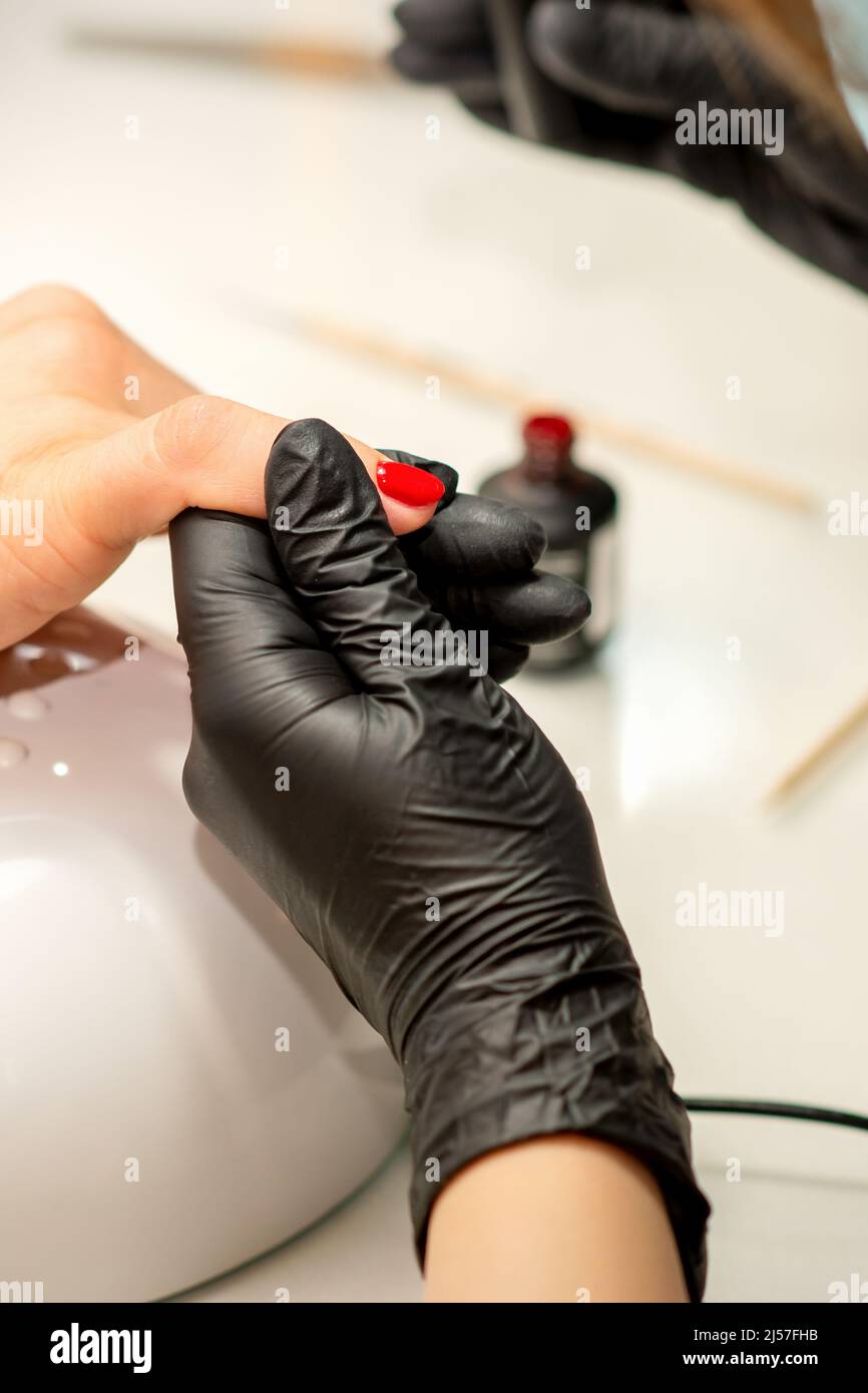 Black woman applying nail paint hi-res stock photography and images - Alamy