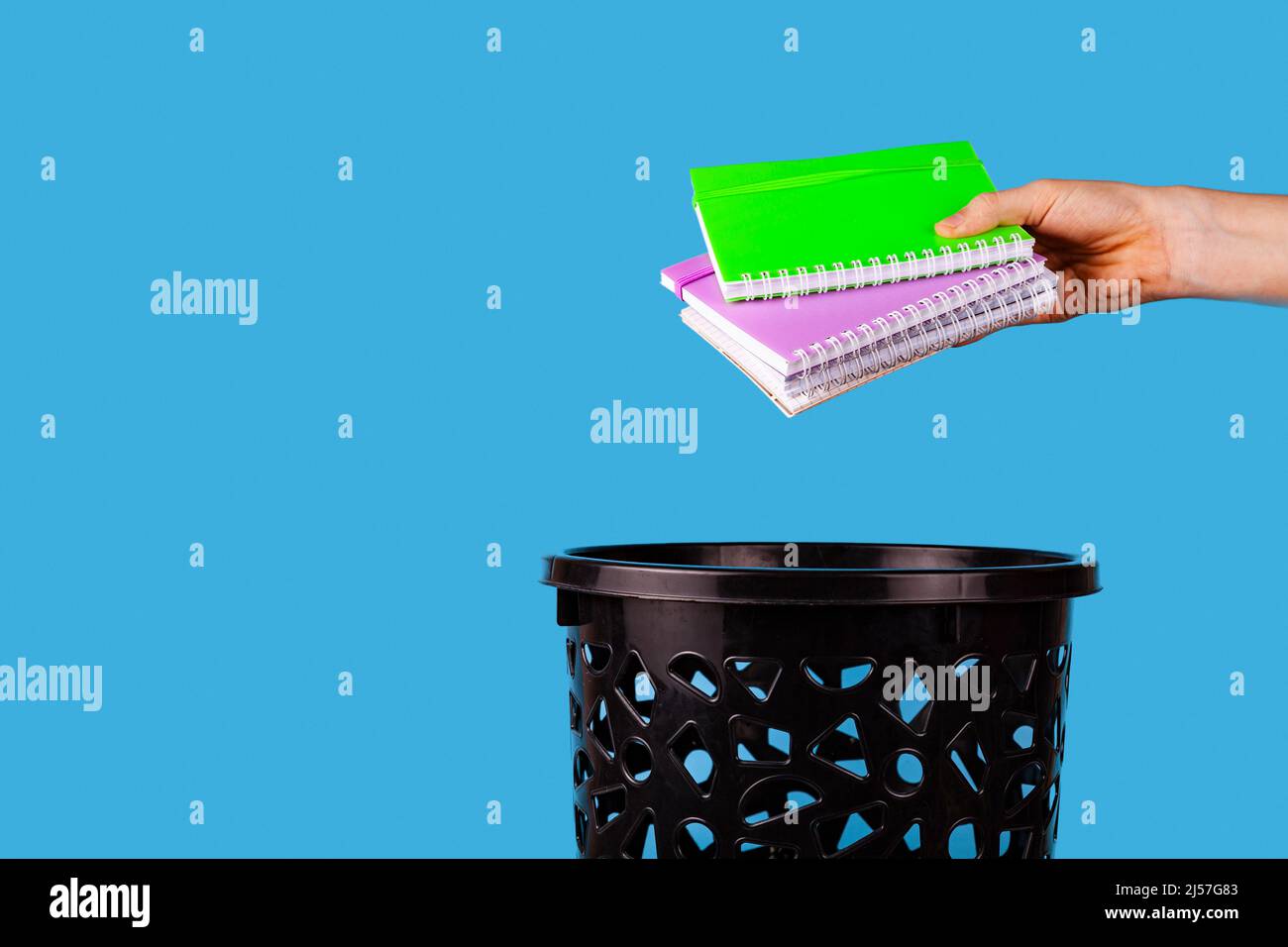 Notebooks are thrown in the trash can. For copy space for designers on ...