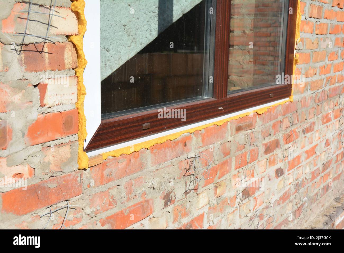 Close up on brick house window installing with insulation Stock Photo ...