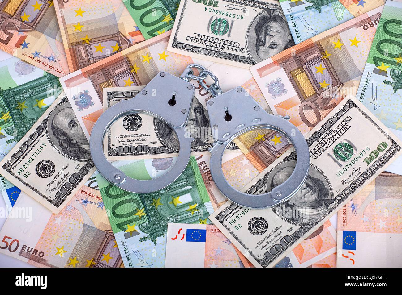 Handcuffs lying on the money. Background of money Stock Photo - Alamy