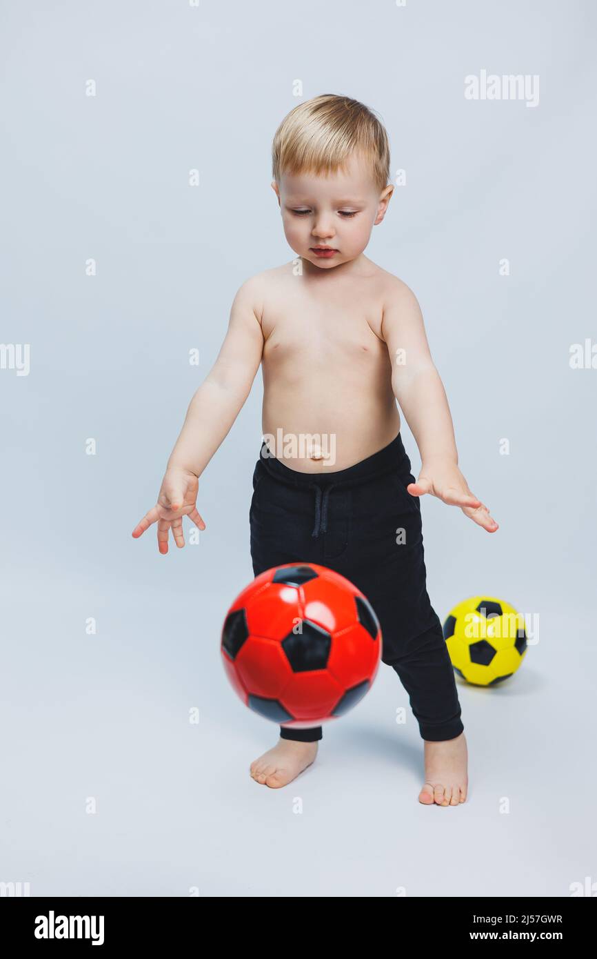 Fan boy holding a soccer ball in his hands, isolated on a white ...