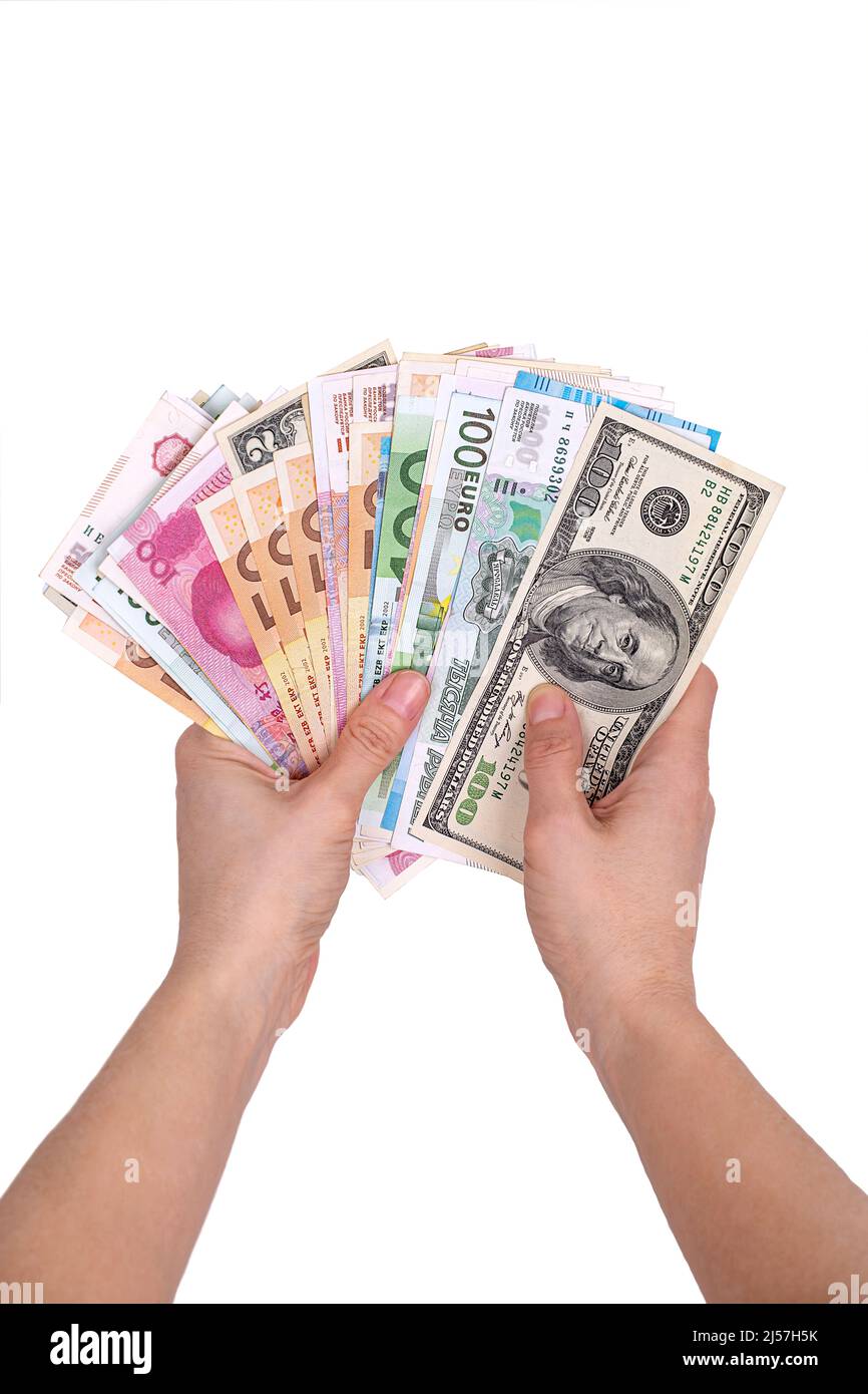 a bundle of money from different countries in women's hands, isolated ...