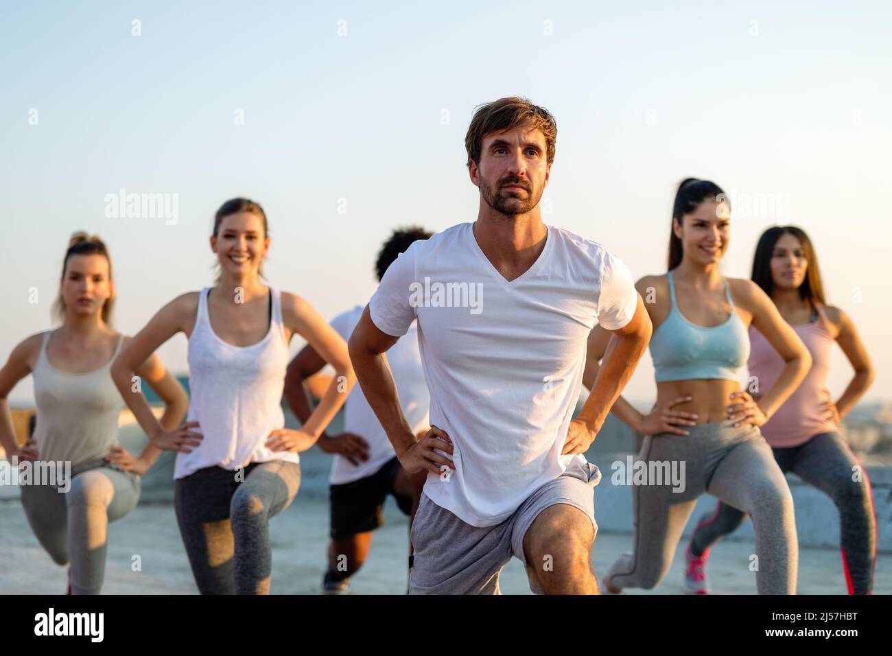 Group of fit people exercising together to stay healthy. Sport people ...