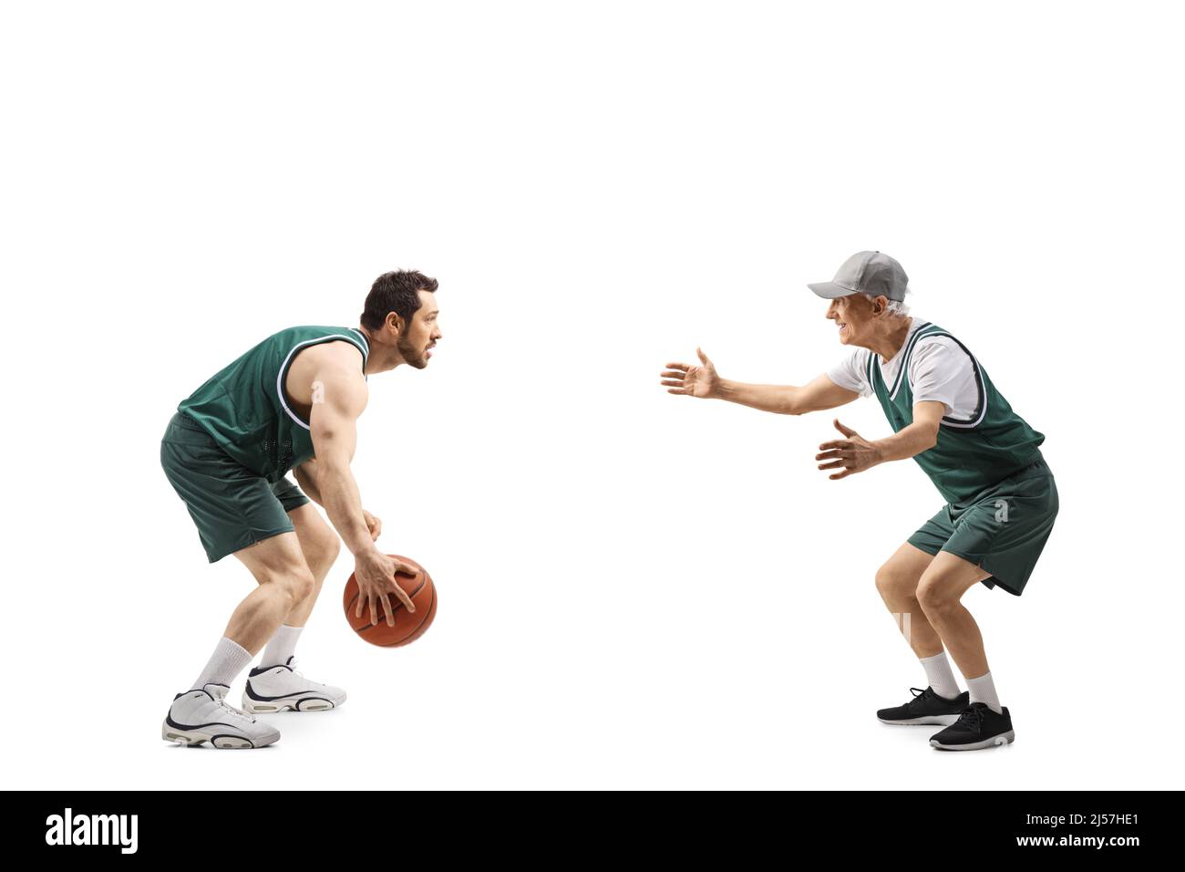 Young and elderly man playing basketball isolated on white background ...