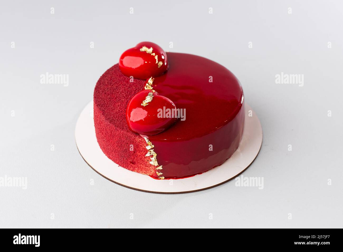Red mirror half glazed and velor entremets with mini hearts and gold ...