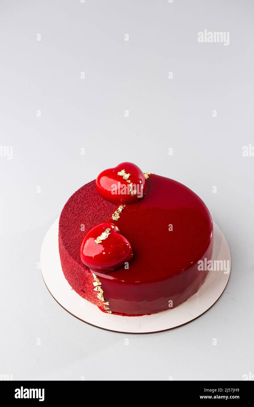 Red mirror half glazed and velor entremets with mini hearts and gold ...