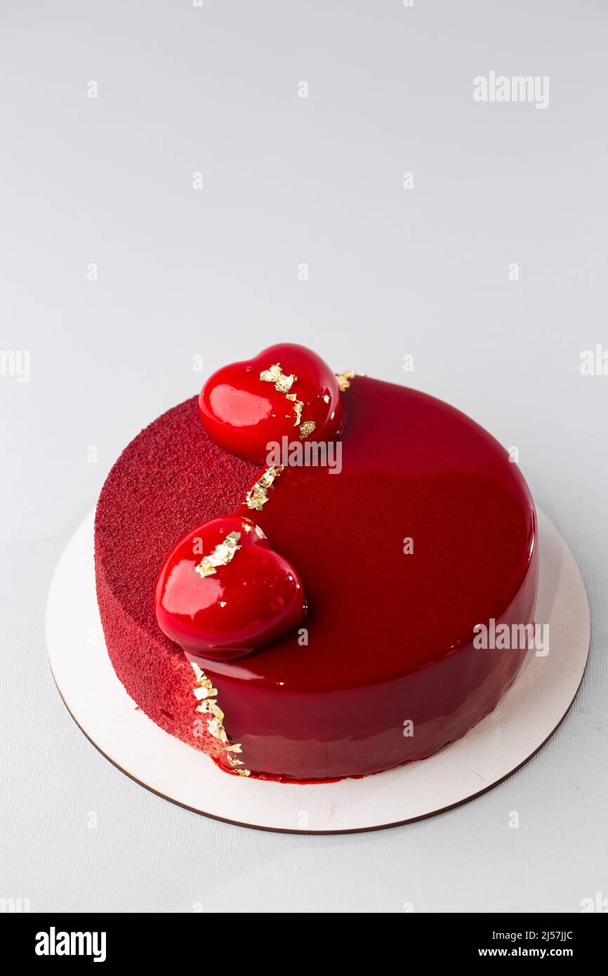 Red mirror half glazed and velor entremets with mini hearts and gold ...