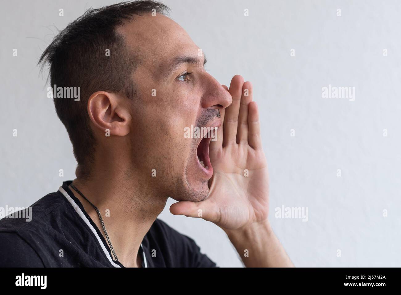 man exclaims with his hands Stock Photo - Alamy