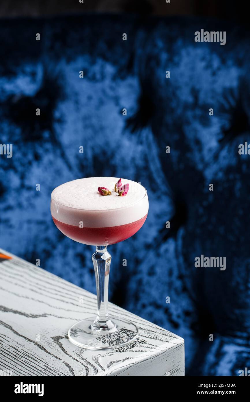 Pink Clover Club Cocktail in Coupe Glass with Layer of Foam and flower ...