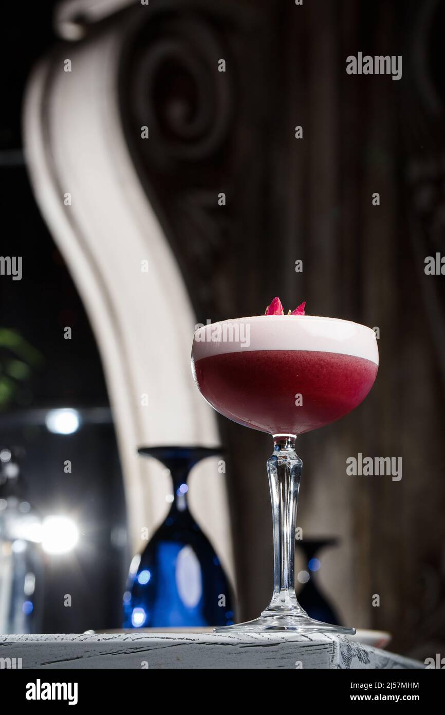 Pink Clover Club Cocktail in Coupe Glass with Layer of Foam and flower ...