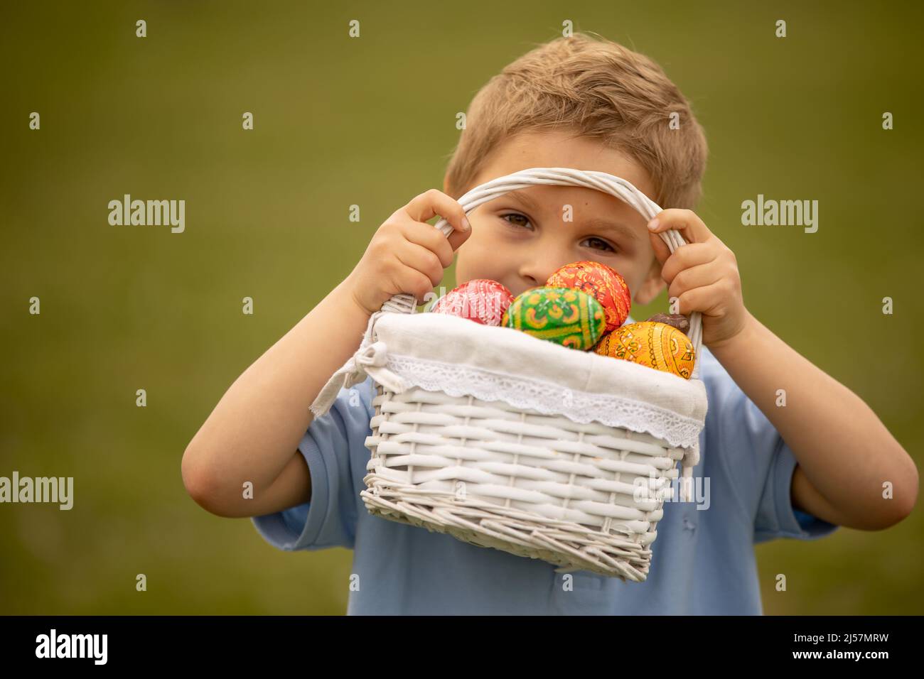 Cute preschool child, whipping his sister on Easter with twig, braided ...
