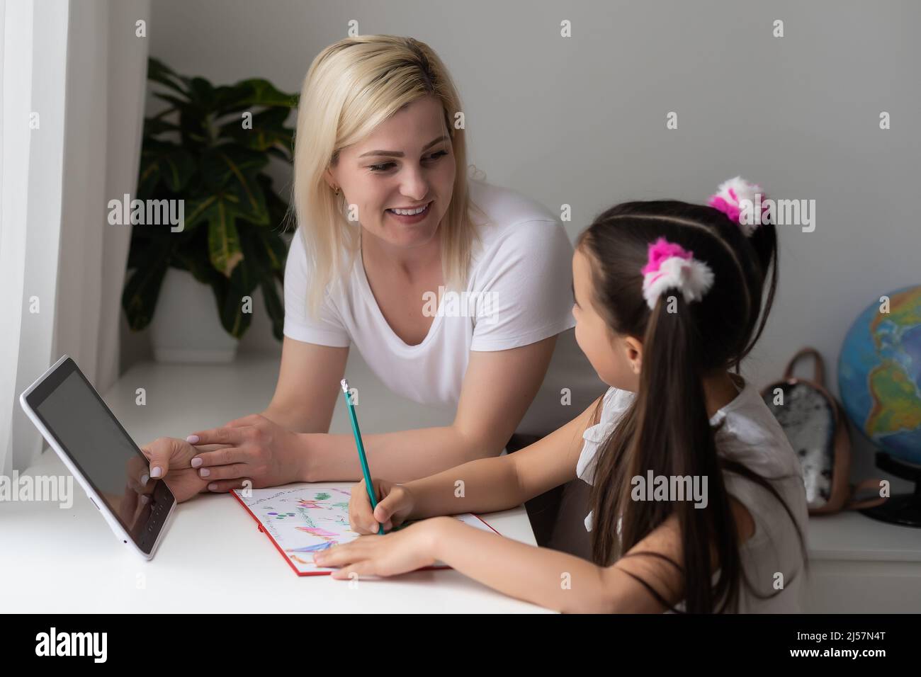 Online education of children. Mother and daughter of preschool watching ...