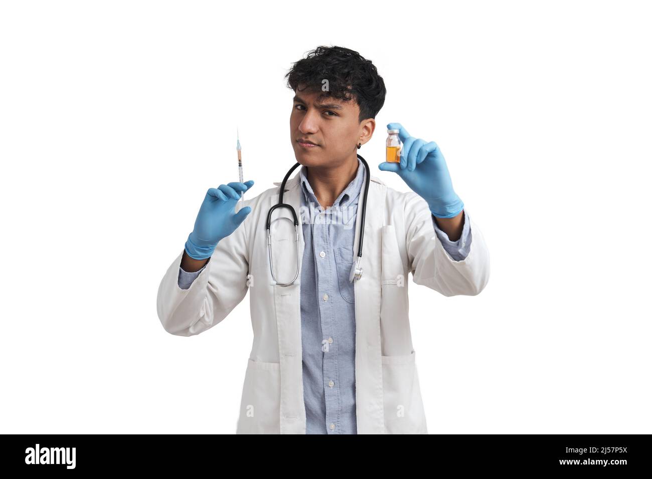 Young peruvian male doctor holding a syringe and a vial, isolated Stock ...