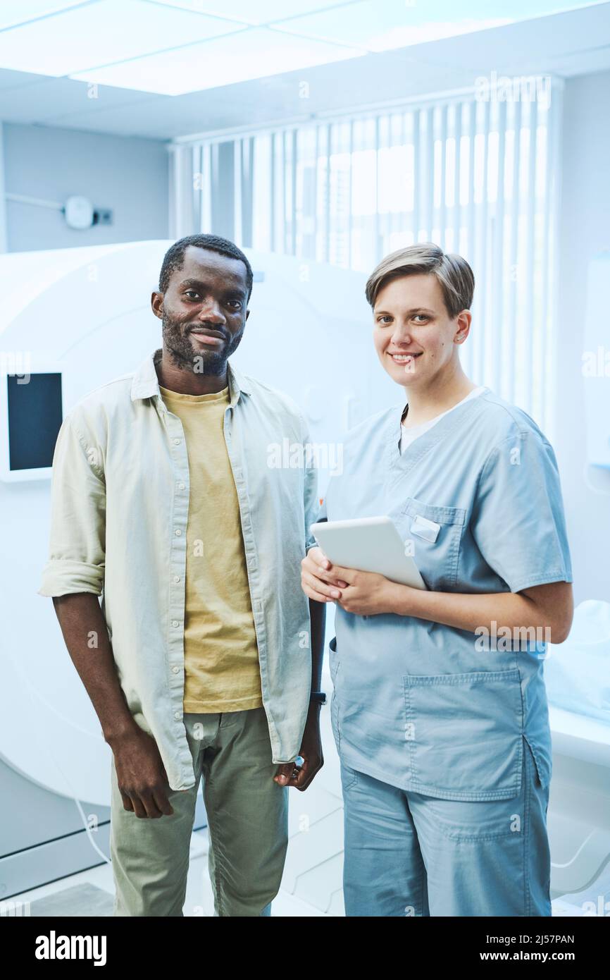 Portrait of content Afro-American patient and female doctor in scrubs ...