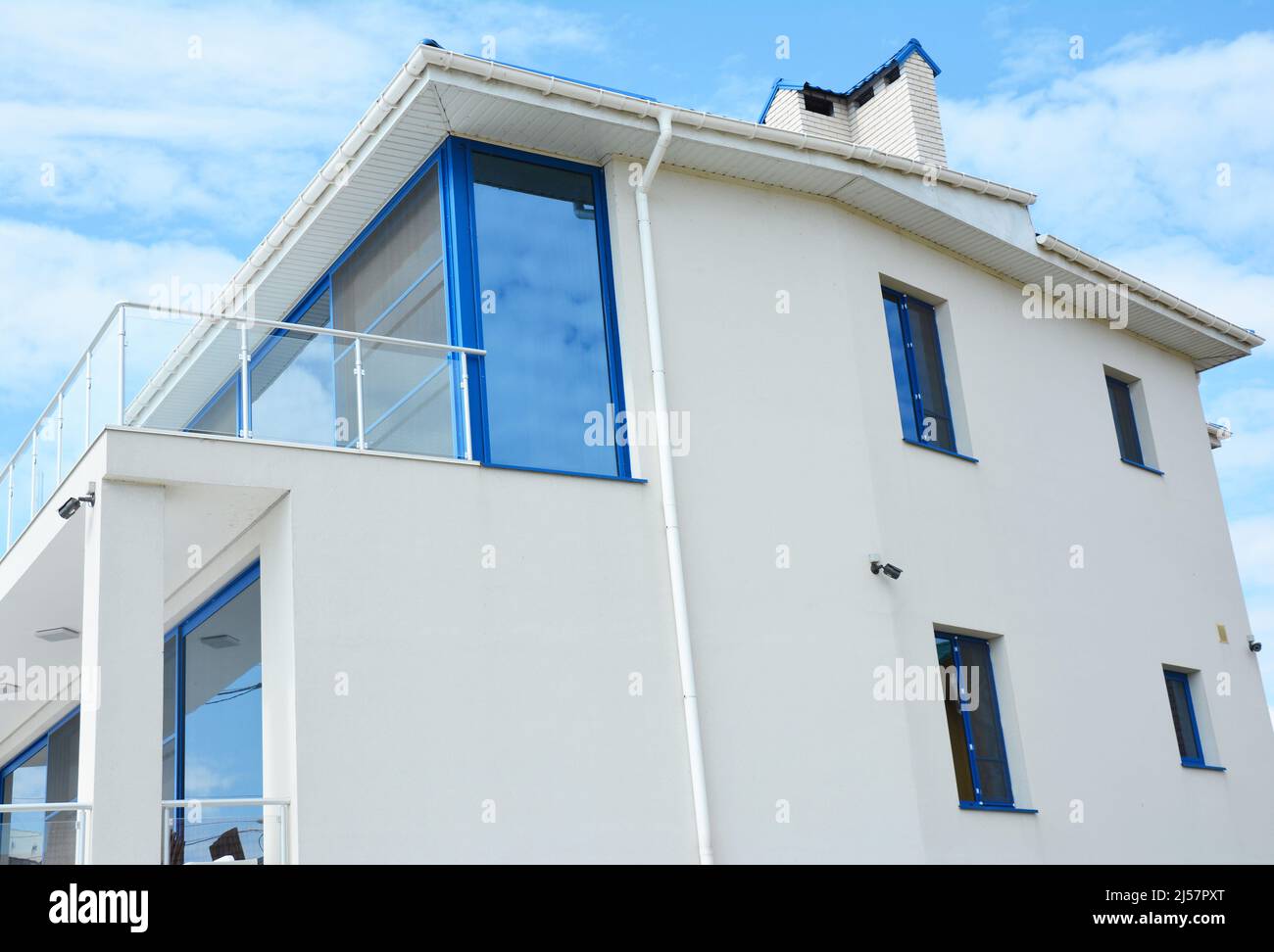 Modern house with white wall, glass balcony, terrace, rain gutter Stock ...