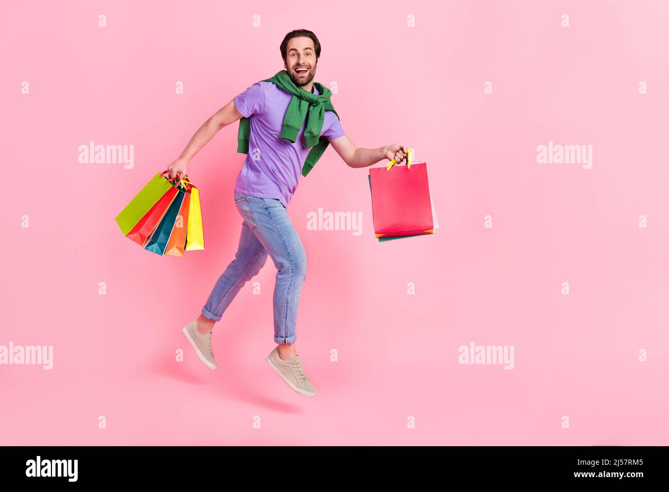 Full size photo of cheerful shopaholic man go shopping buy many ...