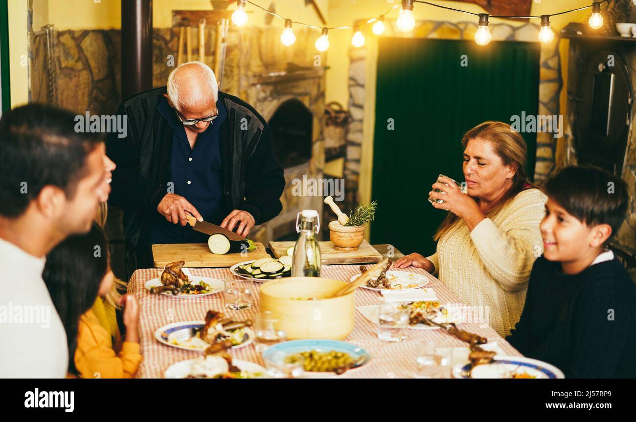 Happy latin family cooking together during dinner time at home - Soft ...