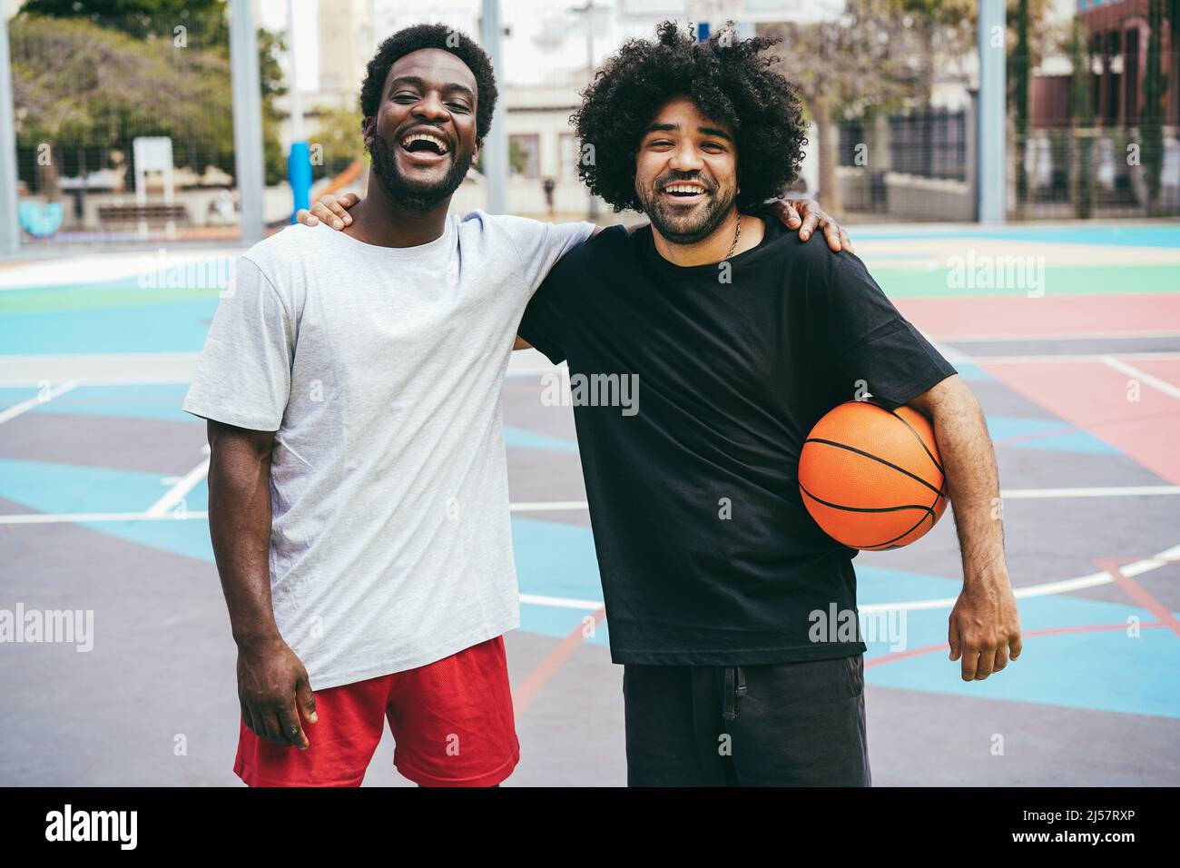 African friends playing basketball outdoor - Focus on left man face ...