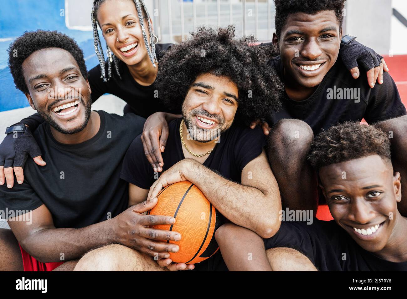 African friends playing basketball outdoor - Focus on center guy face ...