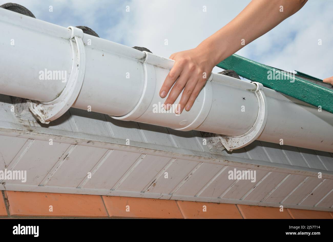 Roofer contractor installing and repair rain gutter. Guttering repair ...