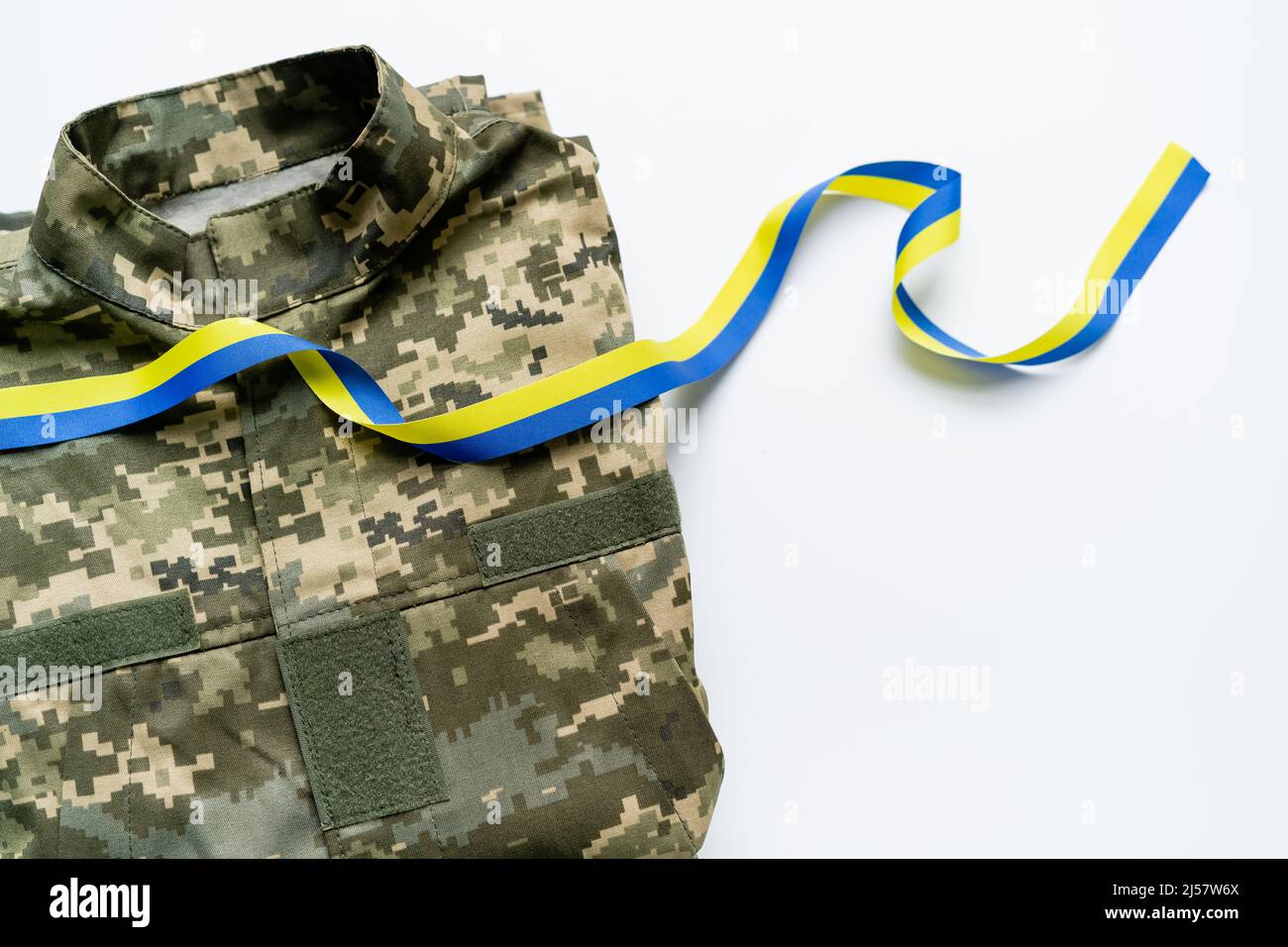 Top view of blue and yellow ribbon on military uniform on white ...