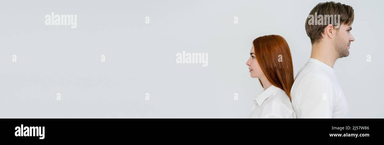 Side view of couple standing back to back isolated on white, banner ...